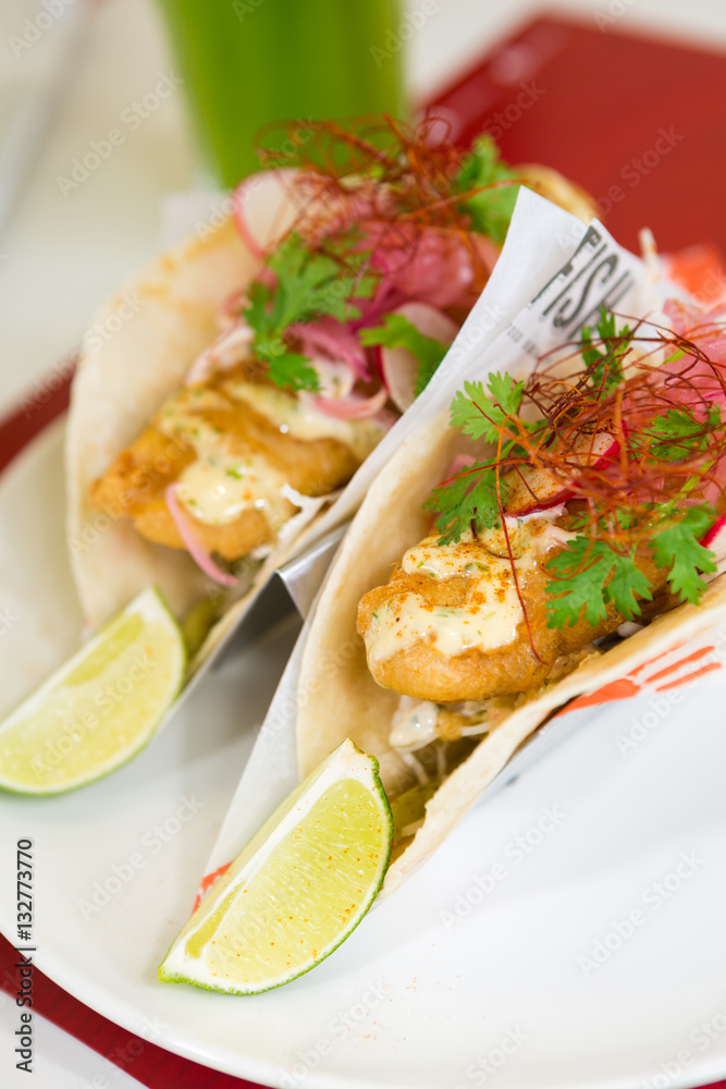 Golden fried cod fish taco served with parsley, red onion hollandaise ...