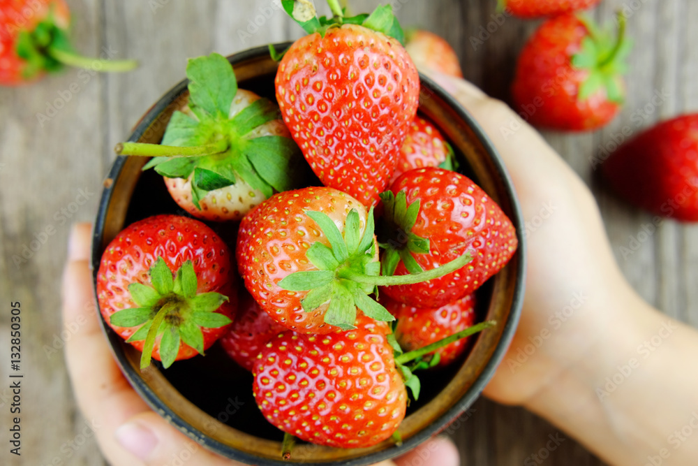 Strawberries in hand. Stock Photo | Adobe Stock