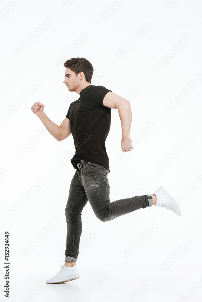 Handsome young man running over white background Stock Photo | Adobe Stock