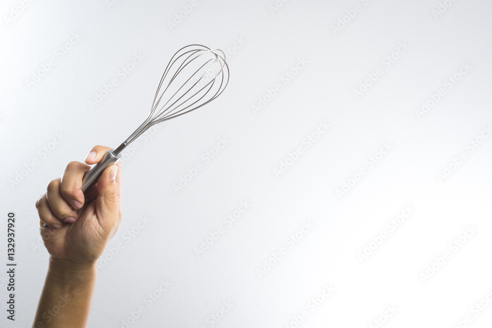 Hand holding stainless balloon whisk Stock Photo | Adobe Stock