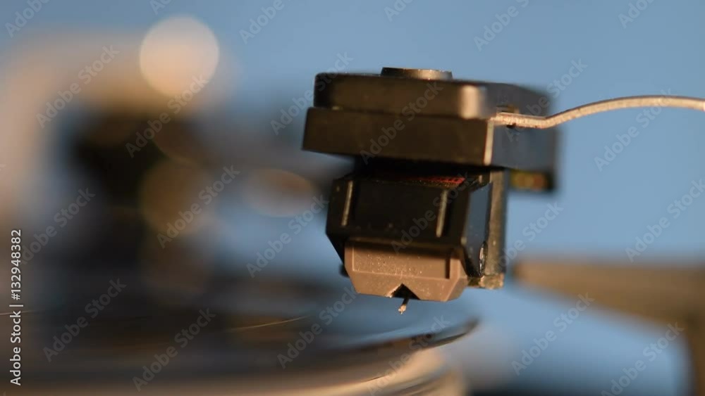 Record player playing an old fashioned vintage vinal record. The needle ...