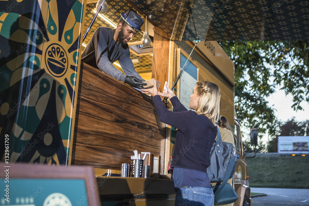 Customer receiving food from vendor at food truck Stock Photo | Adobe Stock