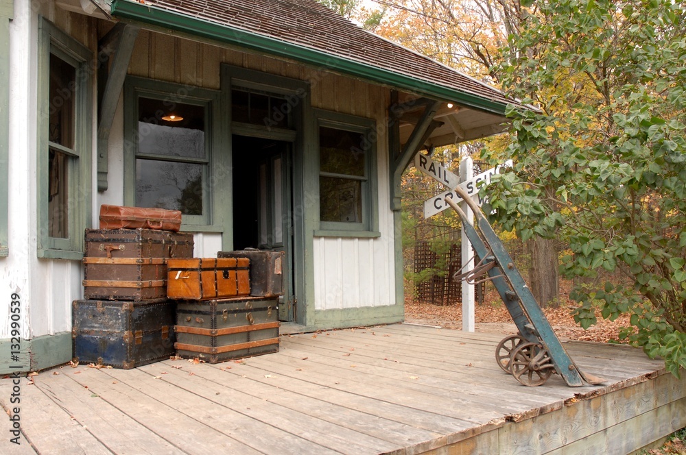 old fashioned train station with wooden platform and vintage luggage ...