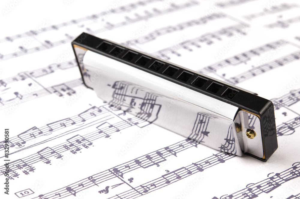 Silver mouth-organ music notes with reflection Stock Photo | Adobe Stock