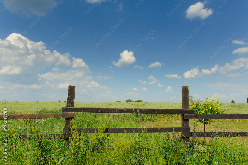 Country Timber Fence. Old wood fence with a green country field behind ...