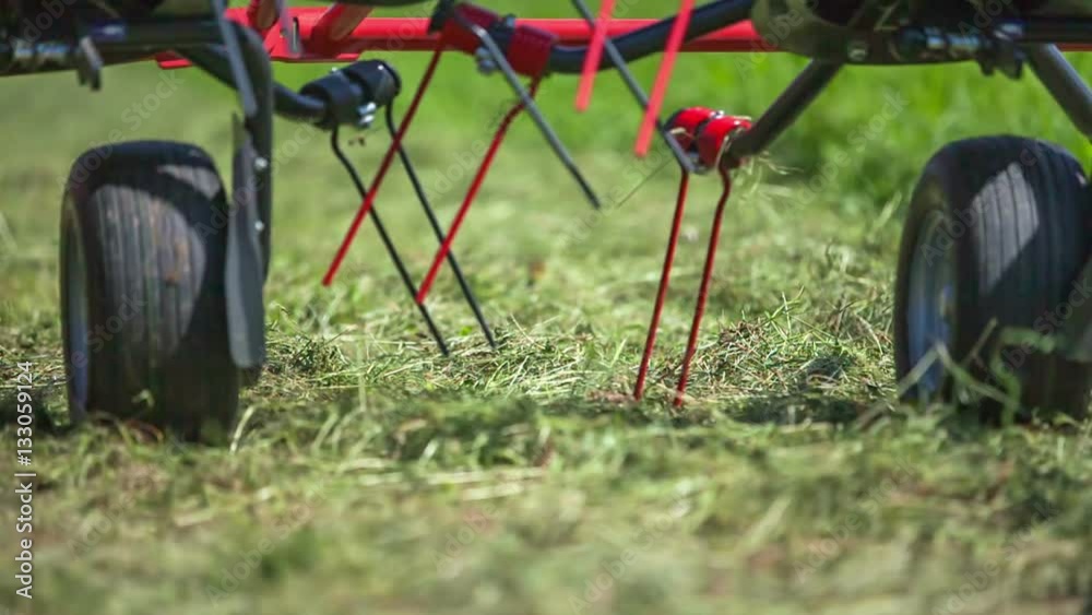 Rotary rakes lower down and they start preparing hay. The hay is flying ...