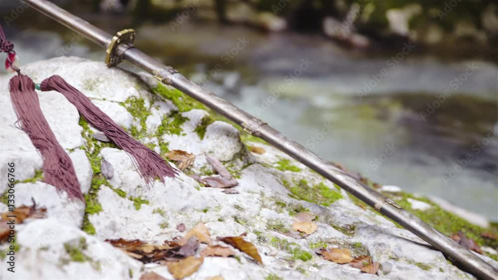 Medieval sword lying on rock by the river panning over 4K Stock-Video ...