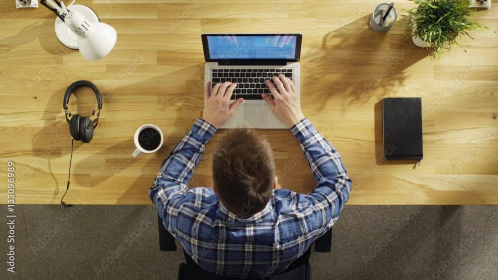 Top View of Young Creative Man Working on His Laptop Beside Him on the ...