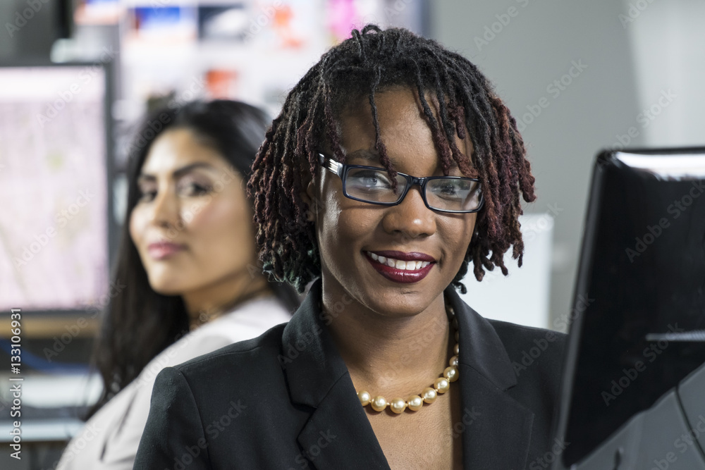 Young black female working at her computer in an office Stock Photo ...