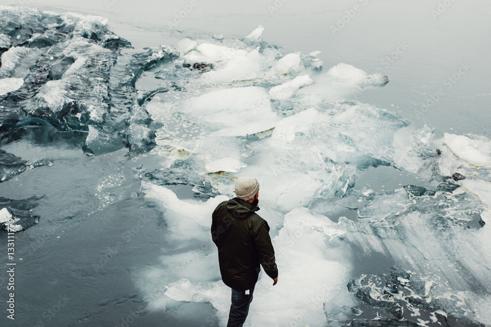 Man standing on ice by sea Stock Photo | Adobe Stock