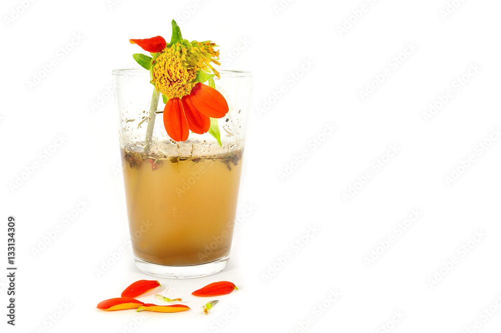Dead flower on a glass with polluted dirty water and some petals on the ...