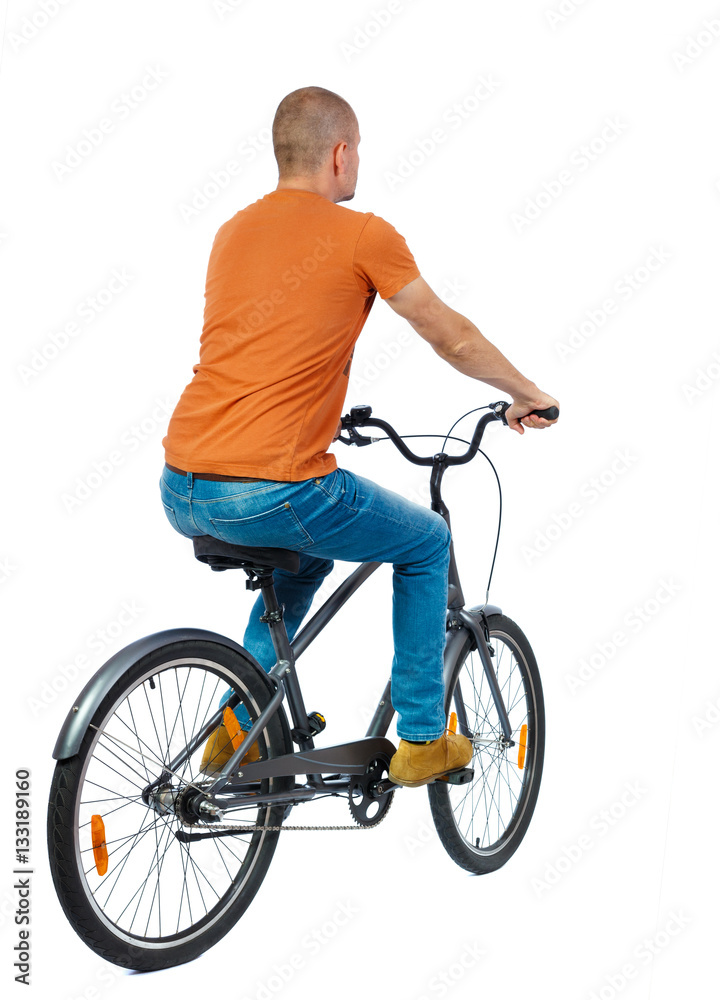 back view of a man with a bicycle. cyclist rides a bicycle. Rear view ...