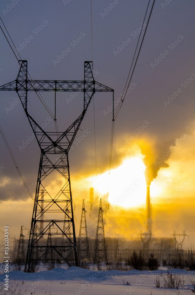 Gas power plant in cold winter landscape during sunset. Pipes with ...