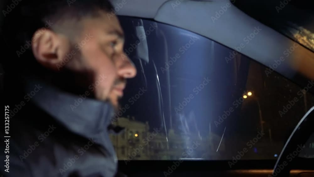 Man behind the wheel of a car driving on the evening streets Stock ビデオ ...