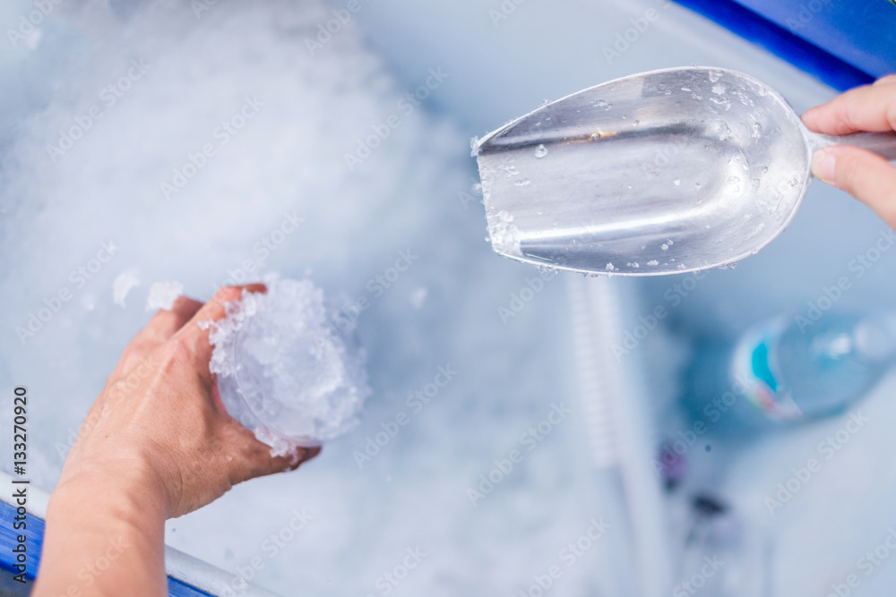 Bartender putting Ice cubes in glass . Stock Photo | Adobe Stock