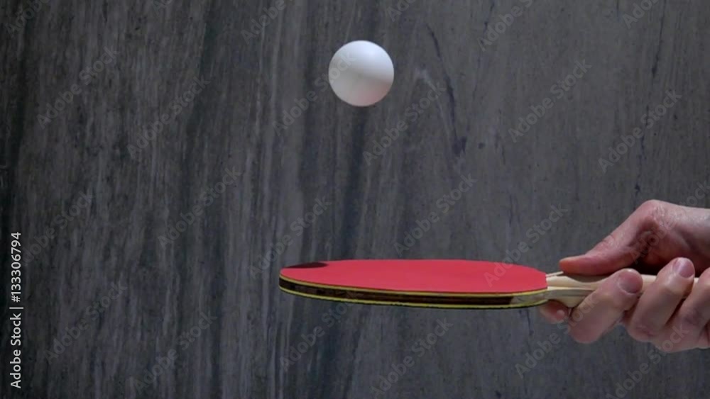 Hand holding table tennis racket and bouncing ping pong ball. Slow ...