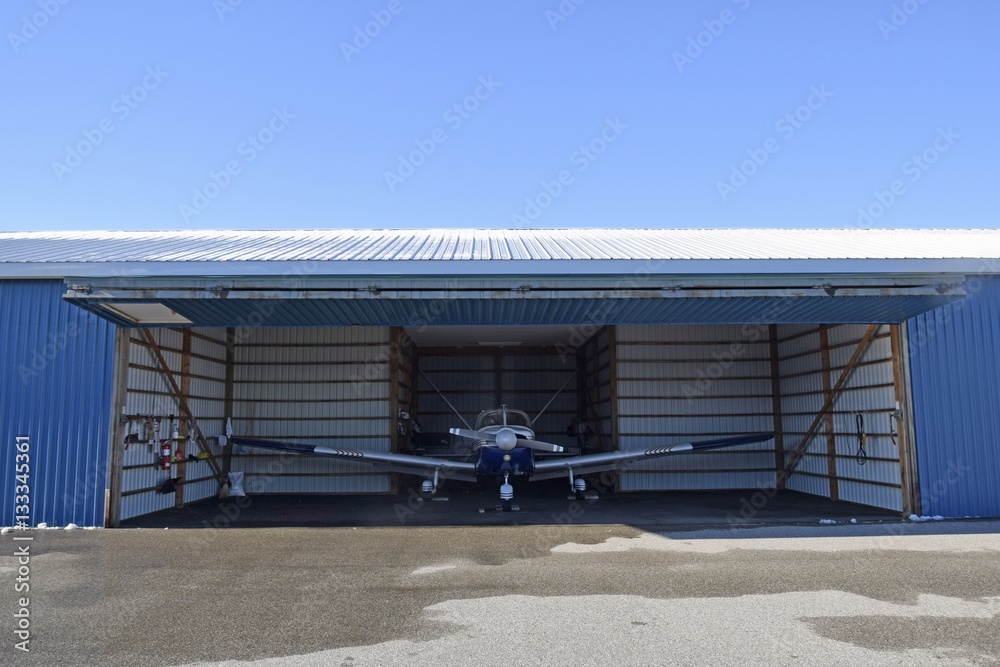open small aircraft hangar with propeller plane parked inside Stock ...