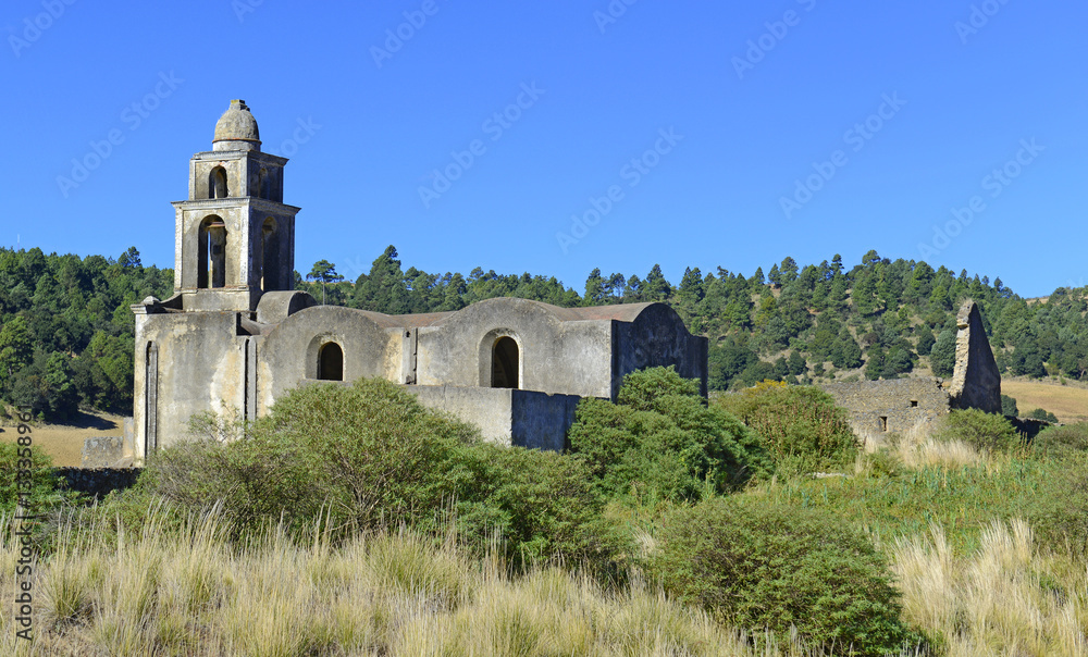 Old abadoned vintage cement church in field near rural village in ...