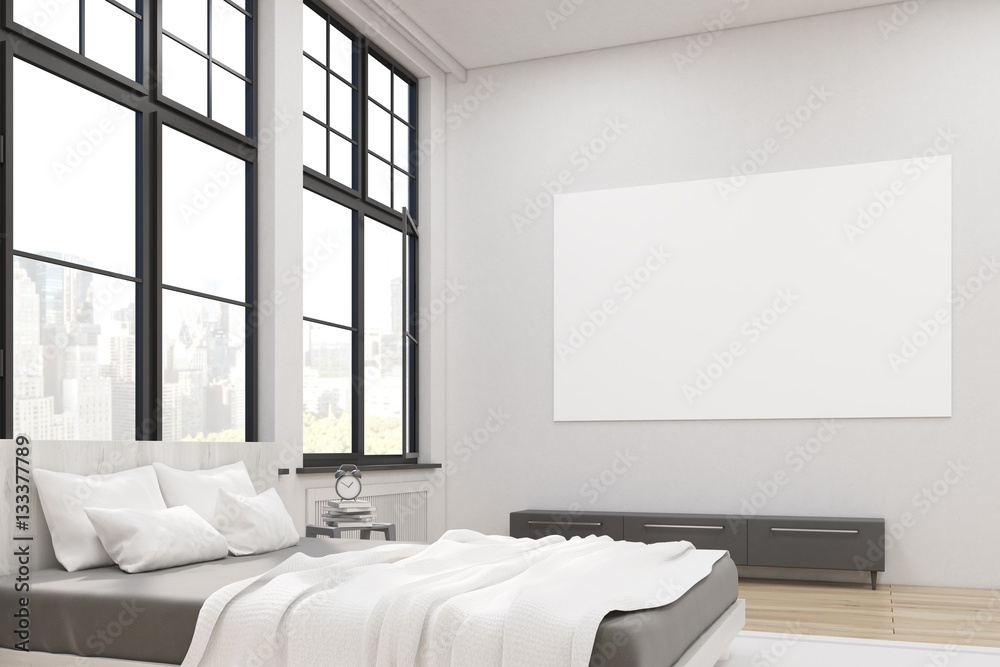 Side view of a master bedroom with a bed, a set of drawers and a large ...