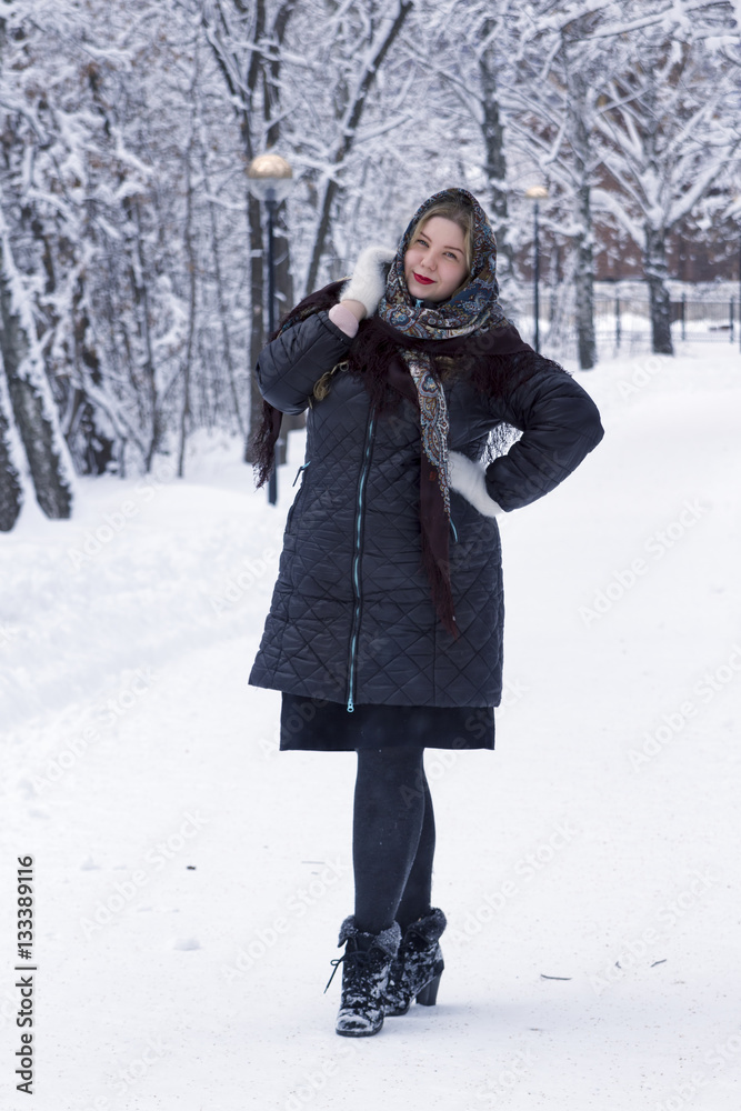 Beautiful young woman posing in winter park, plus size model on a snowy ...