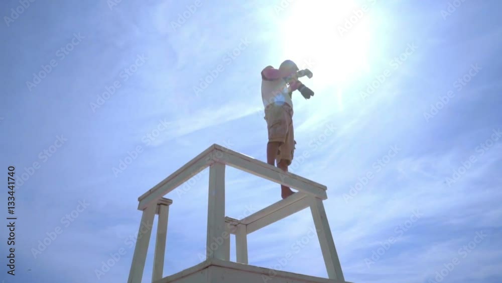 Professional photographer shooting photo from watchtower. Male ...
