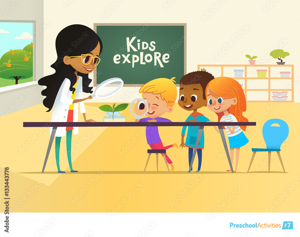 Smiling teacher and children looking through magnifying glass at green ...