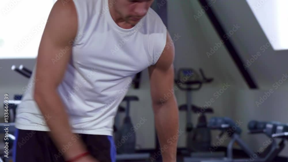 Attractive sportsman finishing his exercise at the gym. Strong male ...
