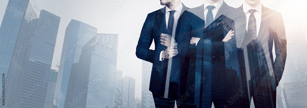 Group of three young businessman wearing suits and posing against ...