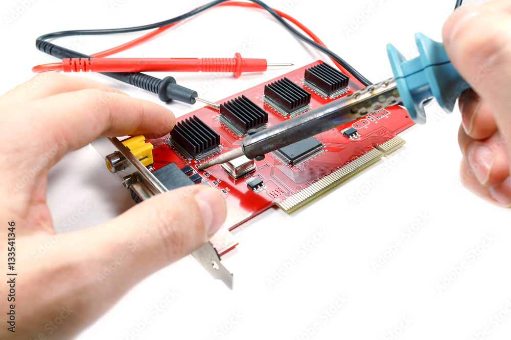 Soldering the diode on the DVR motherboard with a soldering iron on a ...