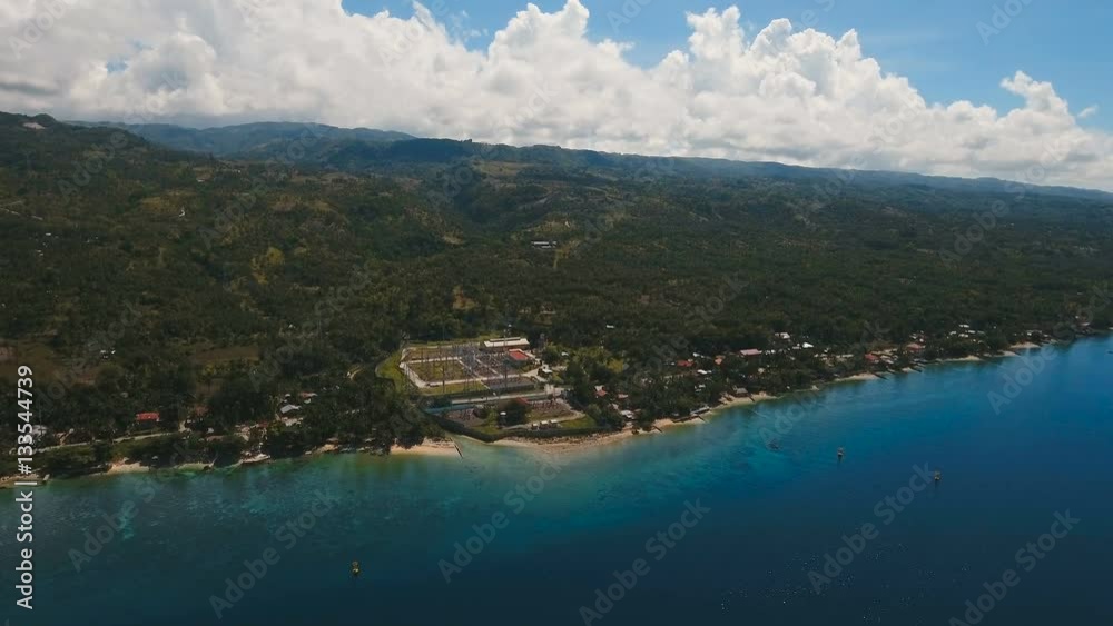 Aerial view high voltage power transformer substation on the sea coast ...