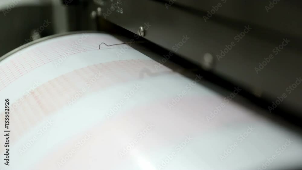 Seismograph records an earthquake on the sheet of measuring paper ...