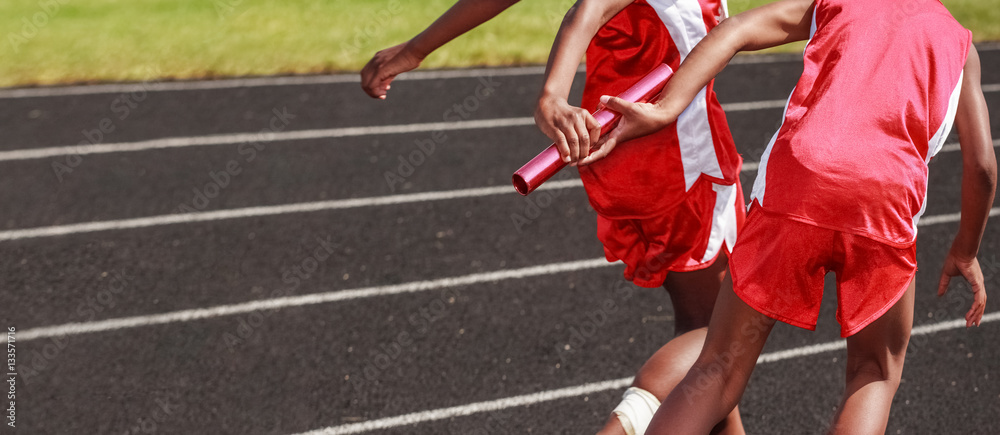 Passing the baton in a relay race Stock Photo | Adobe Stock