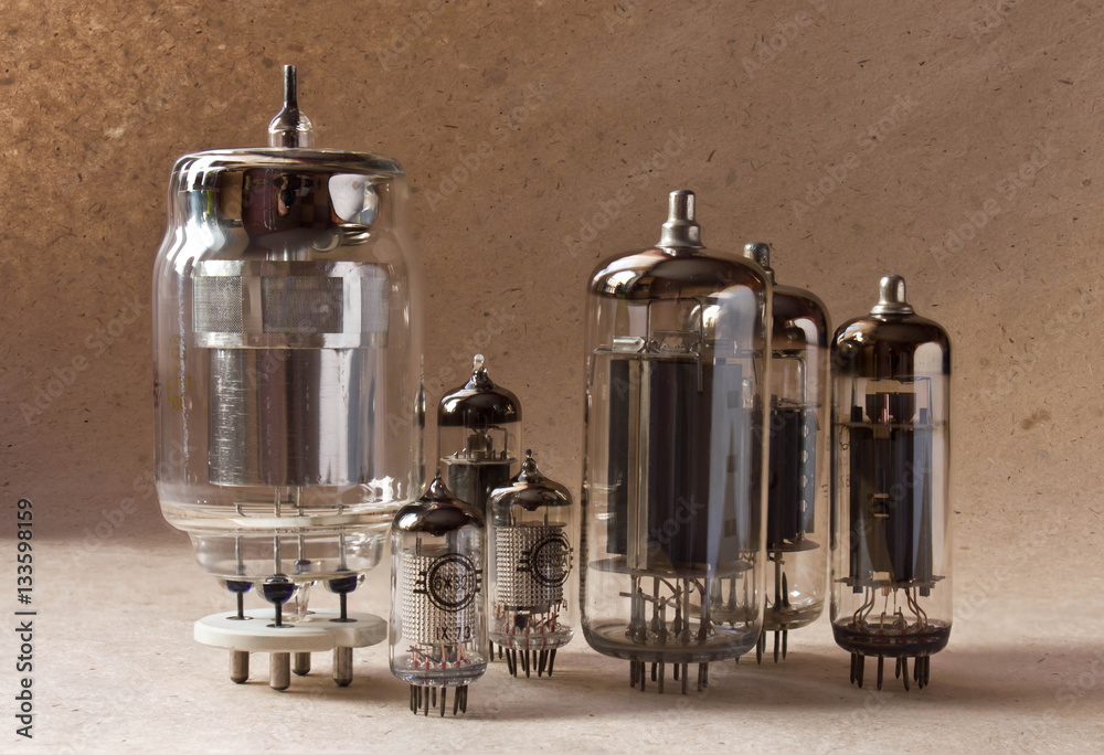 electronic vacuum tubes on kraft paper background in warm colours ...