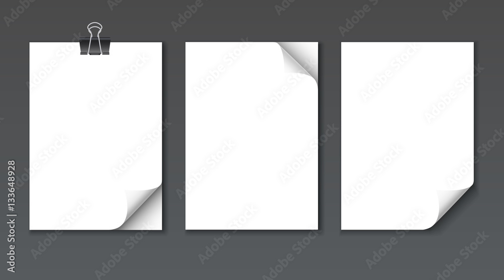 Close up empty paper sheets with curled corner isolated on dark ...