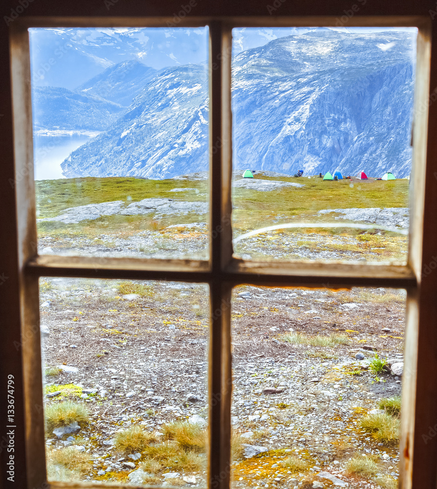 View through vintage window frame at camping site, picturesque ...