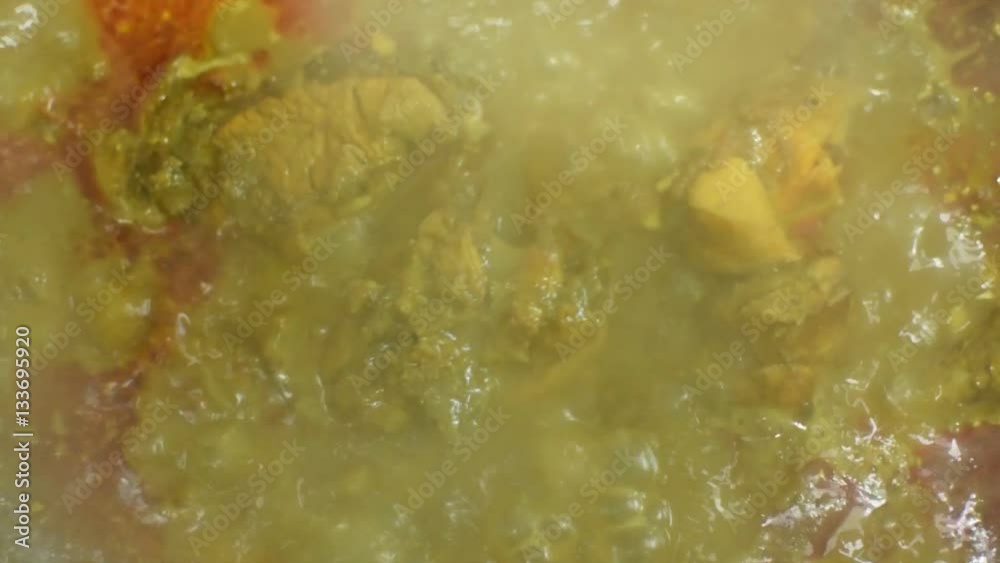 Beautiful close stock footage of Chicken curry cooking, boiling steam ...
