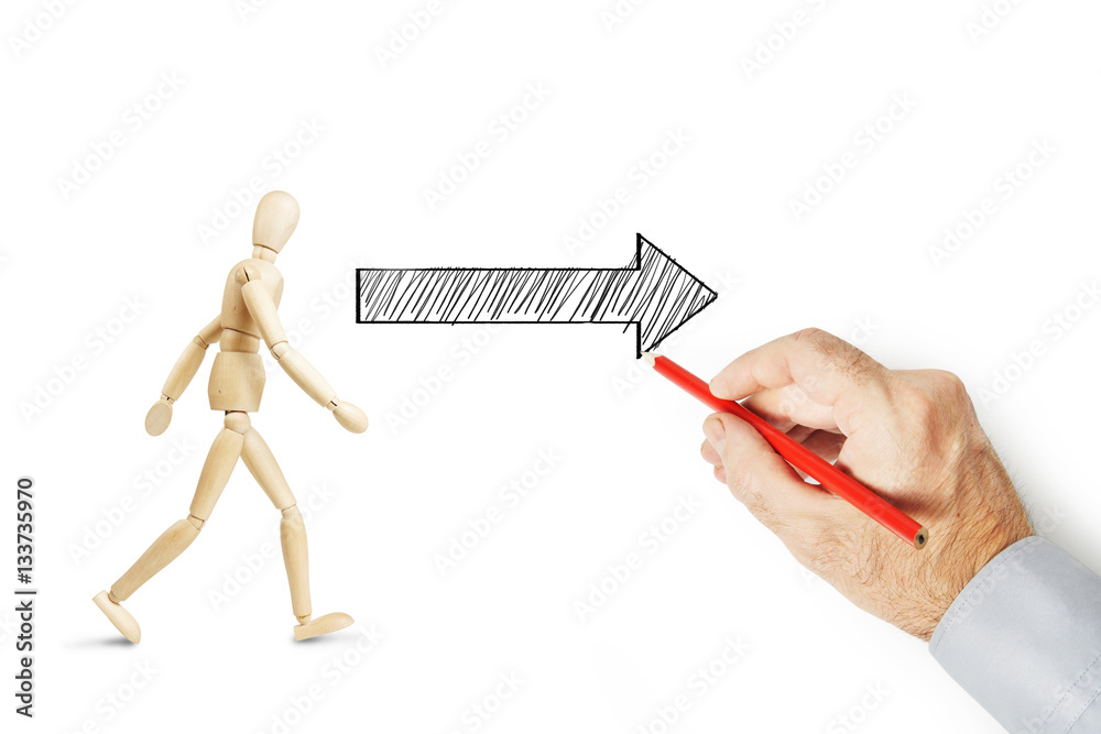 Man draws an arrow and shows the way where to go. Conceptual image with ...