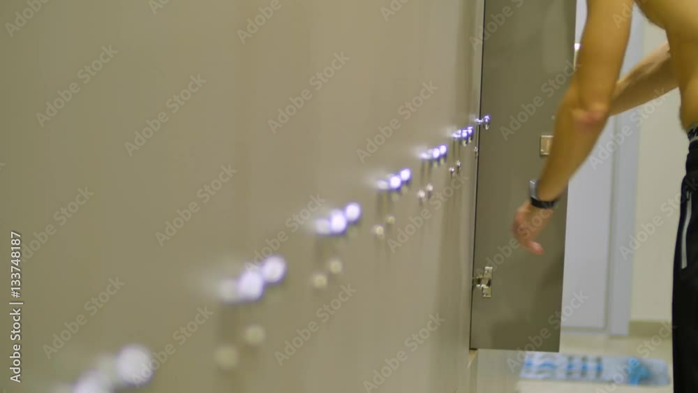 Gym member takes bag from locker. Close detail on the hands of a gym ...