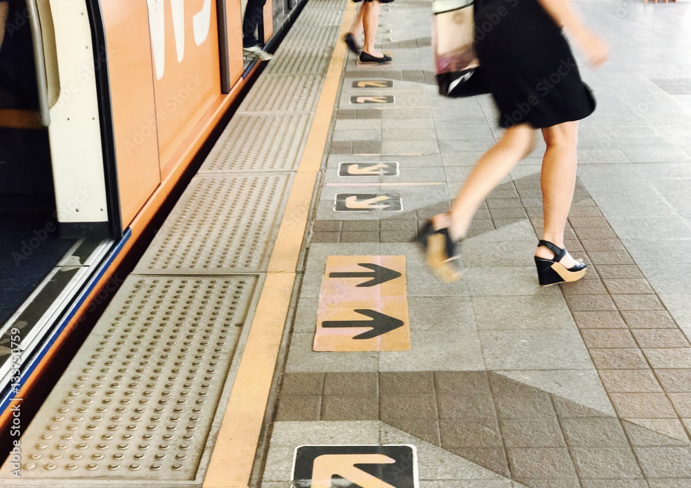 woman rushing out the train towork Stock Photo | Adobe Stock