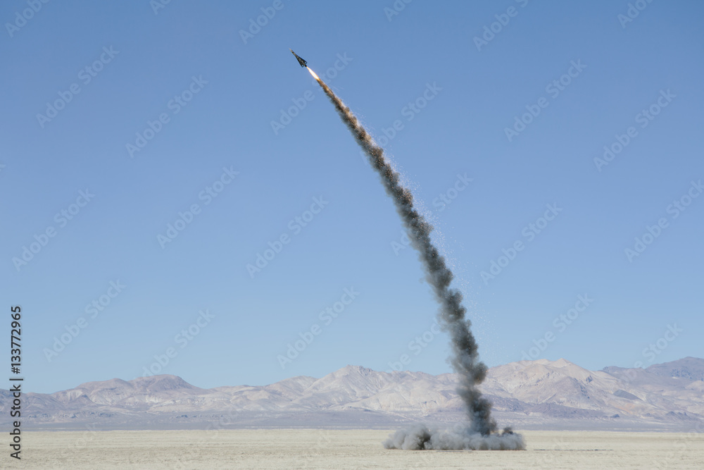 Rocket shooting into vast, desert sky, Black Rock Desert, Nevada, USA ...