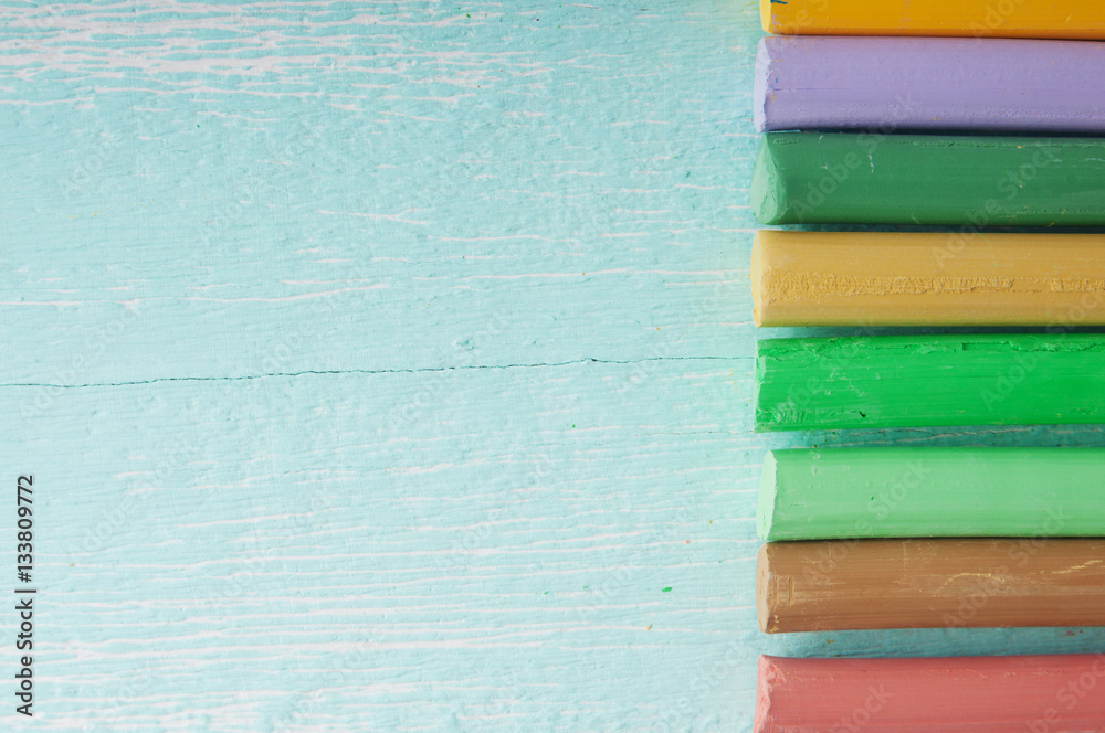 Pastel on turquoise wooden surface Stock Photo | Adobe Stock