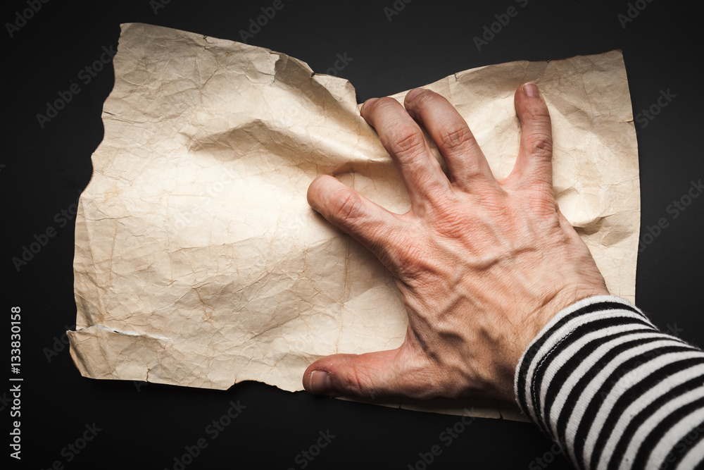 Hand catching empty old crumpled paper Stock Photo | Adobe Stock
