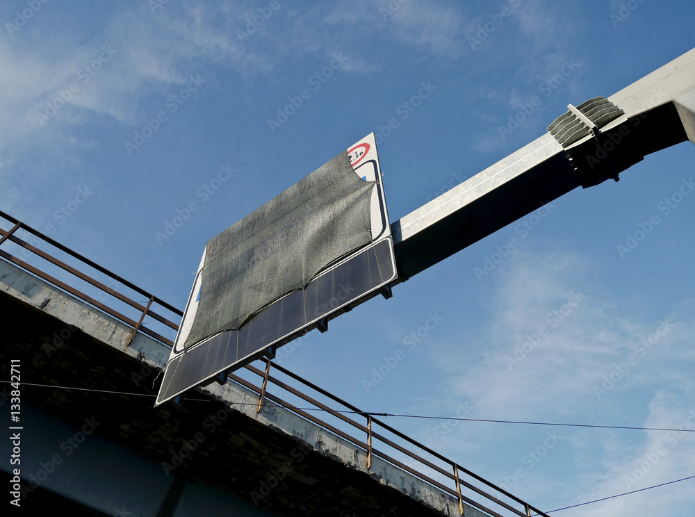 Street sign covered by a green tarp. Stock Photo | Adobe Stock