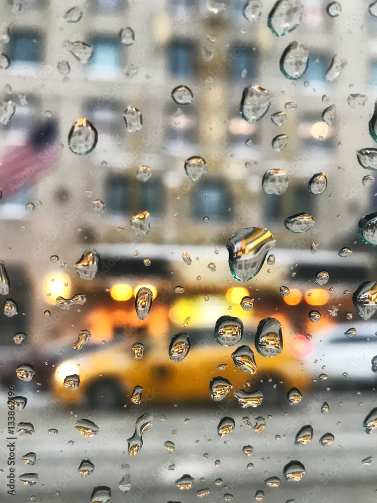 Rain drops on the window with New York City street background Stock ...