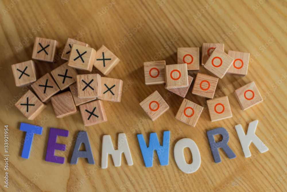 Symbolizing teamwork with wooden blocks and colored letters with foto ...