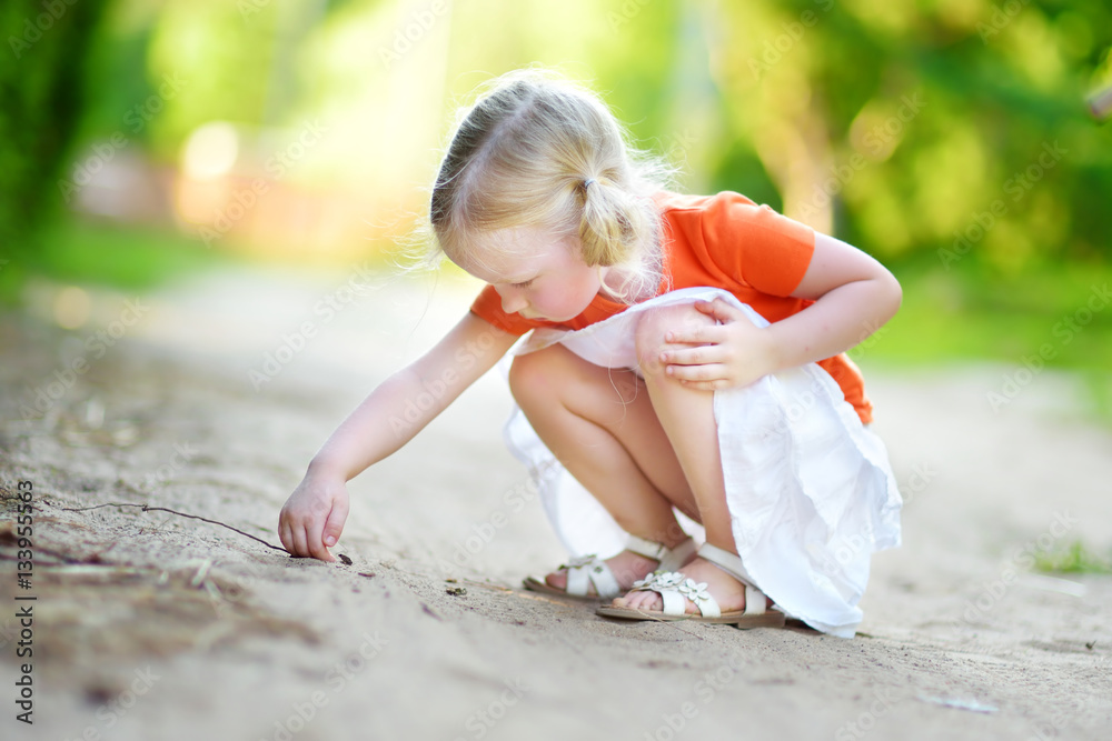 Adorable little girl catching little babyfrogs Stock Photo | Adobe Stock