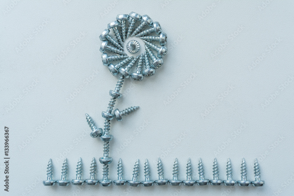 flower on grass, abstract composition of screws Stock-Foto | Adobe Stock