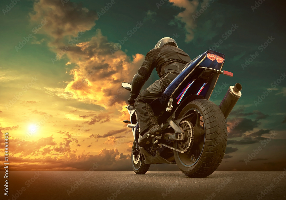 Man seat on the motorcycle under sky with clouds Stock Photo | Adobe Stock