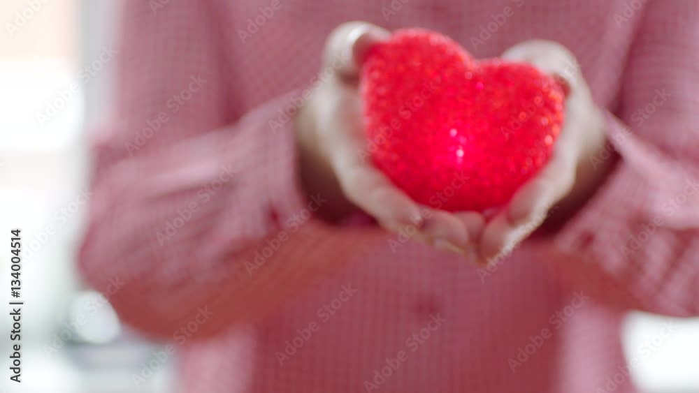 Woman giving away her heart Stock Video | Adobe Stock