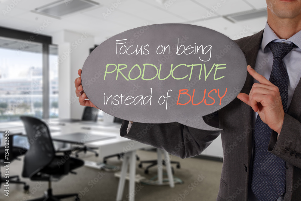 Focus on being productive instead of busy. Businessman holding ...